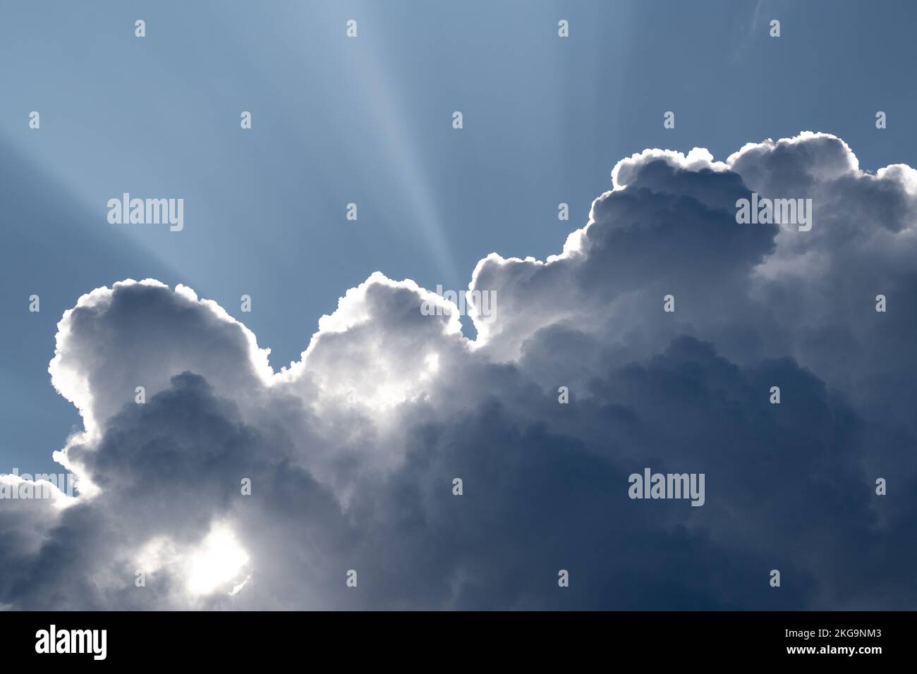 A closeup of the sun rays coming through white clouds, a cloudy weather ...