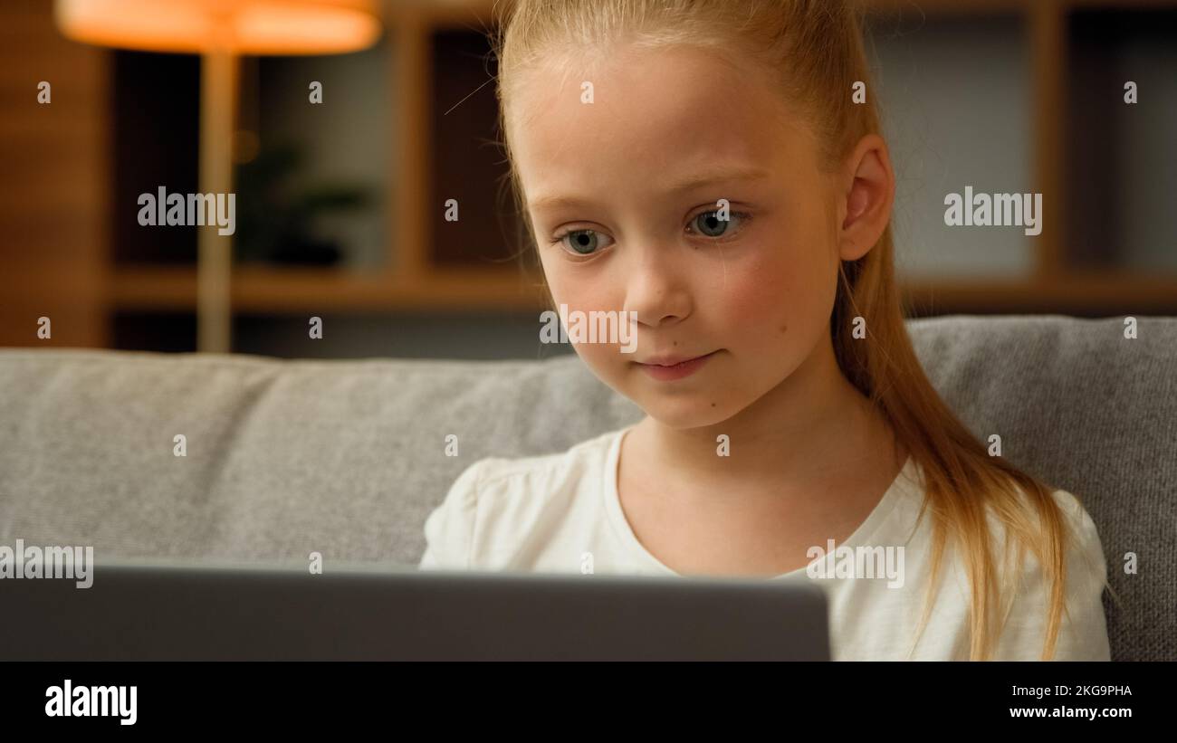 Child girl little kid toddler primary schoolgirl study with computer play online video games at ...