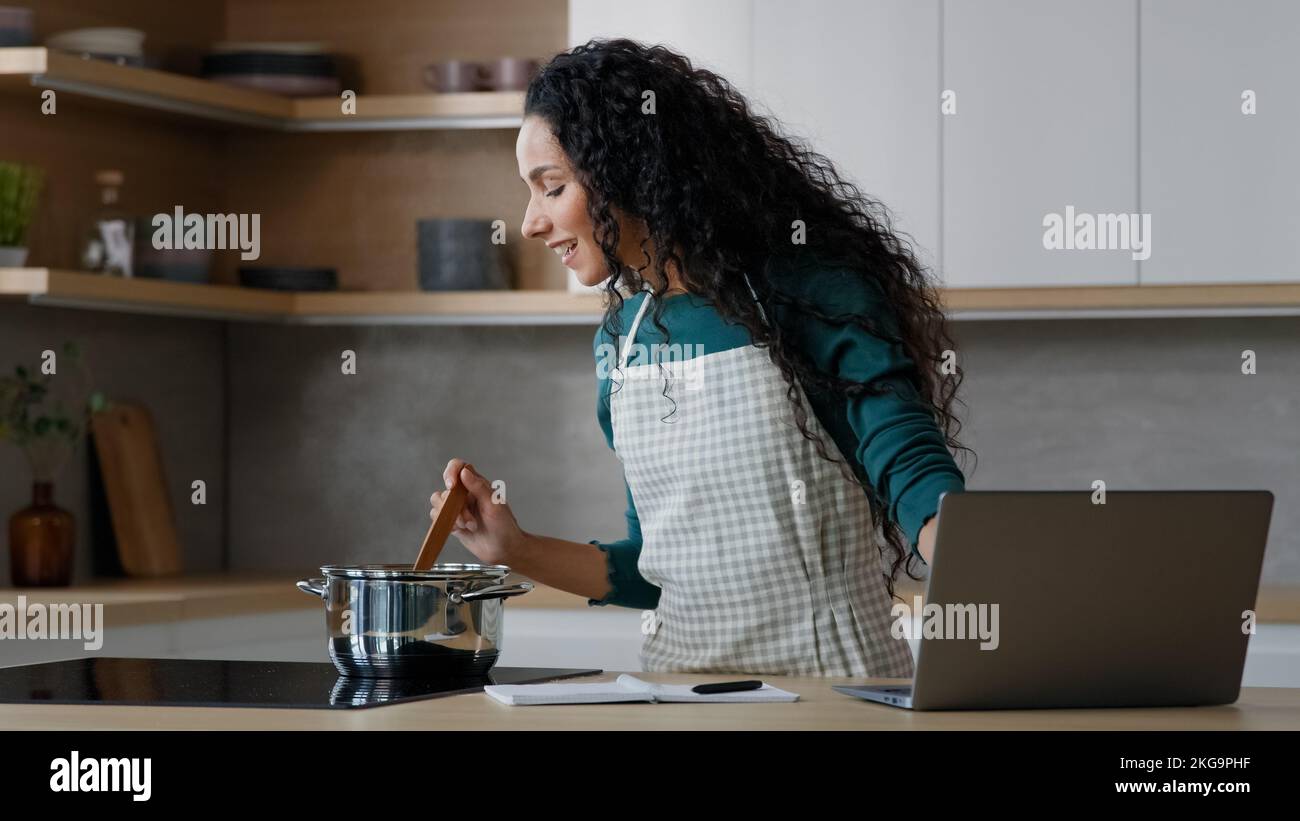 Young Female Chef Arabian Spanish Woman Watching Online Tutorial