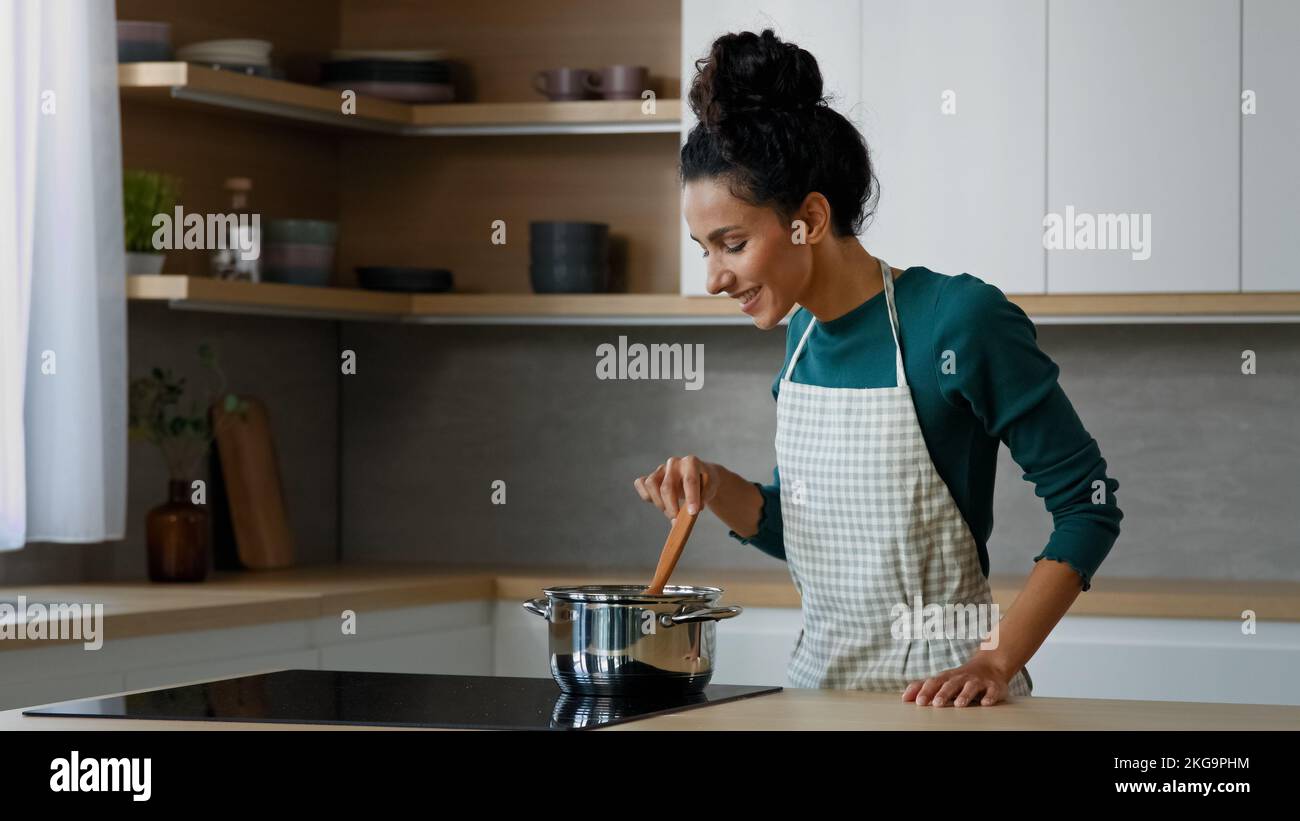 Female chef arabian woman cooker wife mother cooking aromatic dish on ...