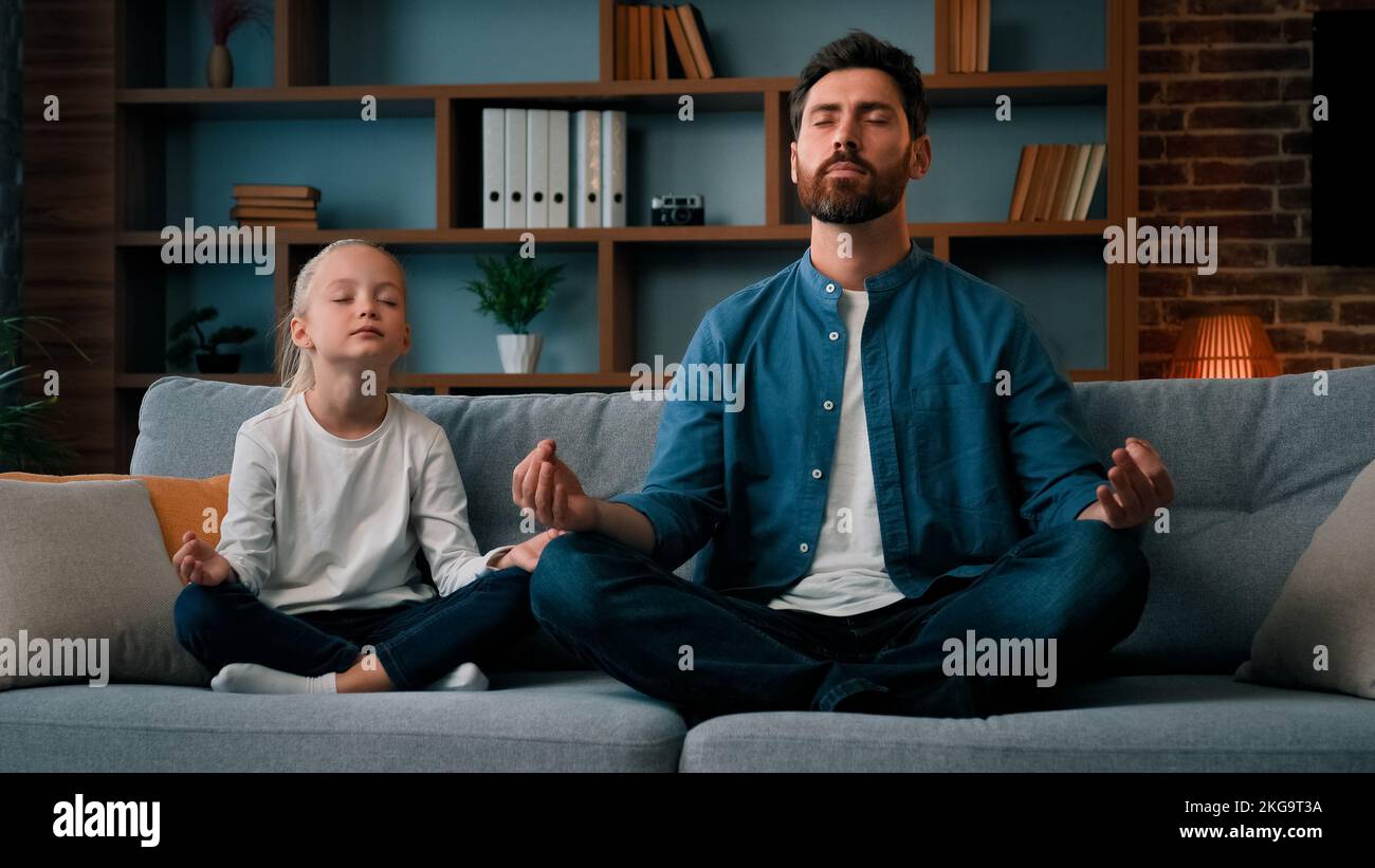Healthy caucasian family practice yoga together sit in lotus pose young ...
