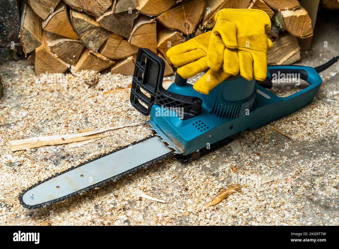 electric chain saw and protective leather work gloves Stock Photo - Alamy