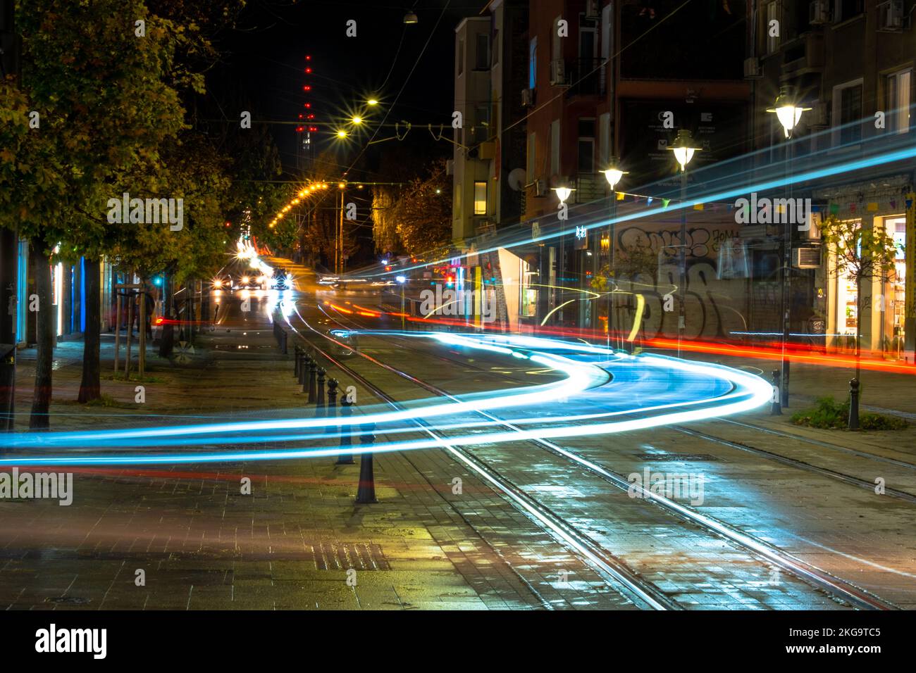 Night scene of tram in traffic at crossing with lighttrail Stock Photo ...