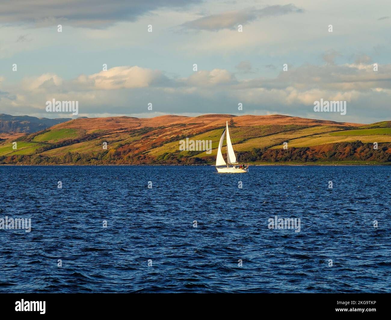 Sailing off the western coast of the Isle of Bute, with rolling hills ...