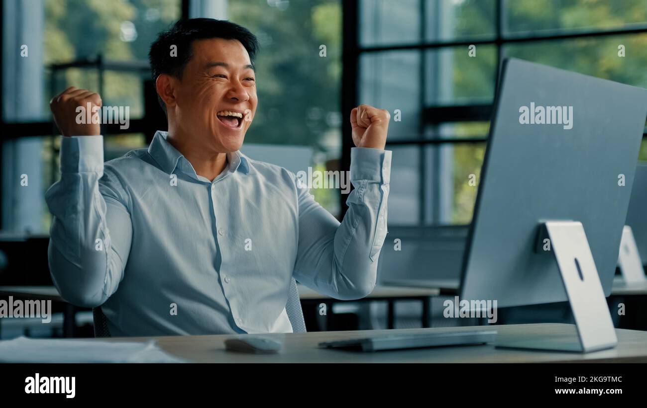 Senior happy emotional businessman male winner investor 40s asian ...