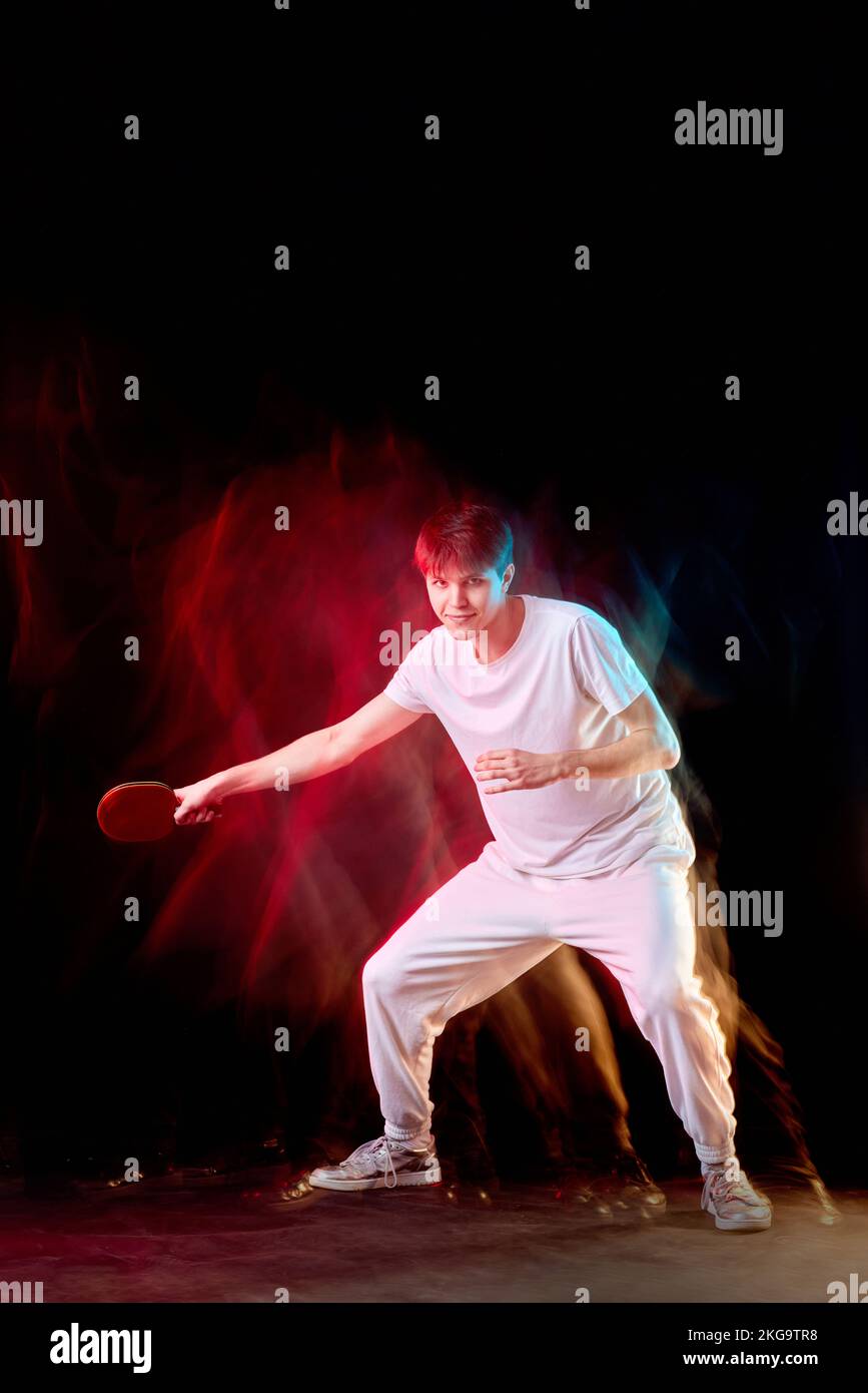 young man playing table tennis in mixed neon light Stock Photo - Alamy