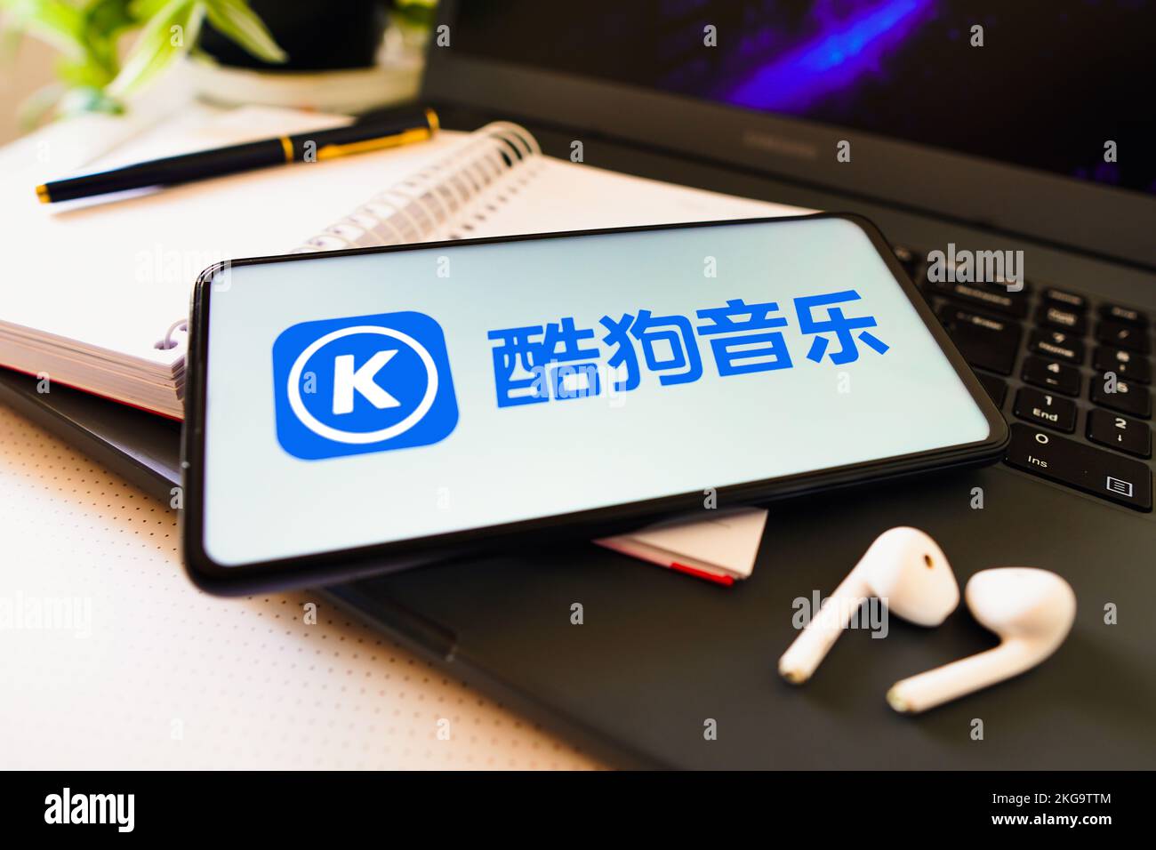 In this photo illustration, the KuGou logo is displayed on a smartphone ...