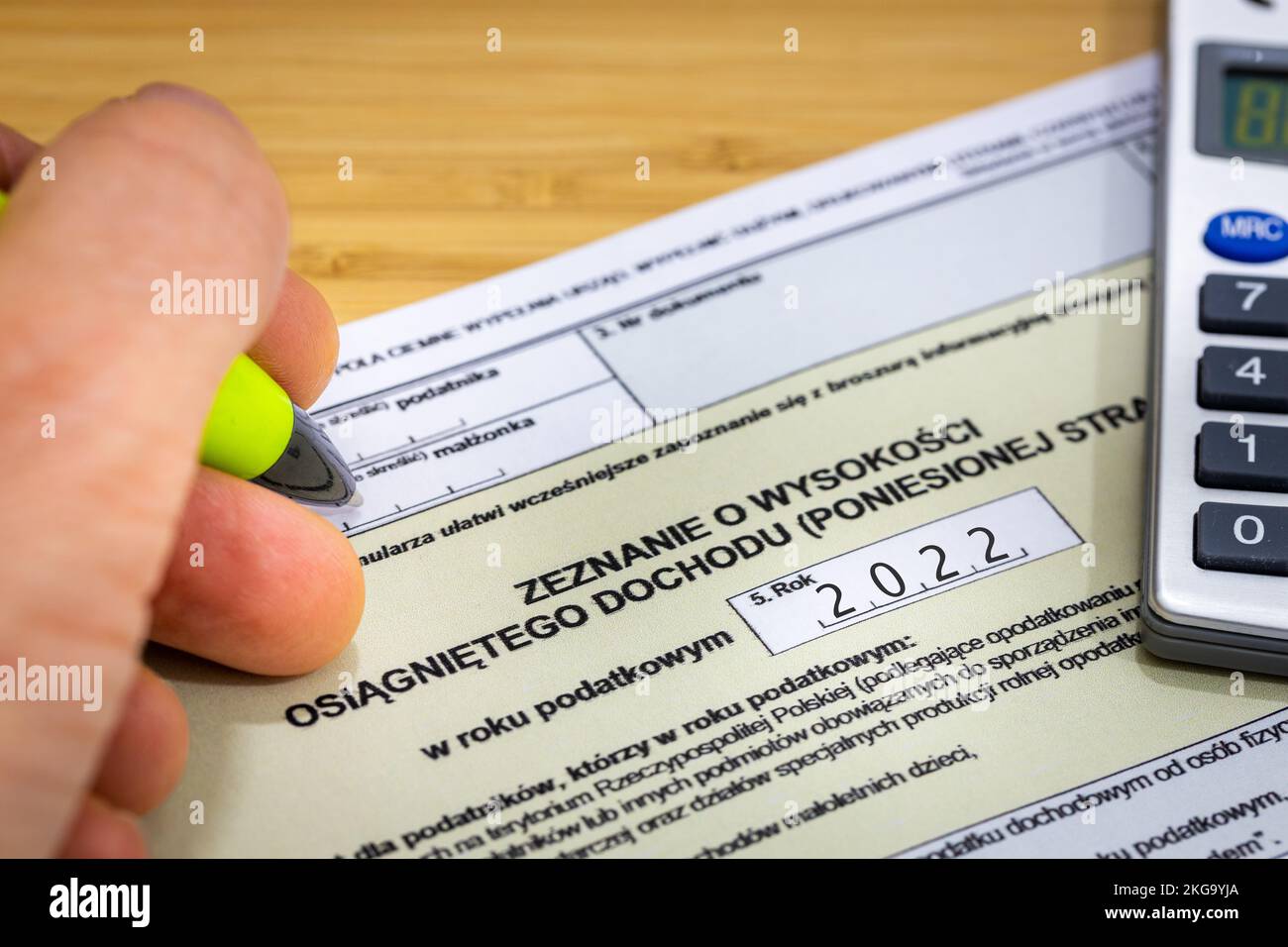 Hand of a person filling in the annual tax return to the tax office in ...