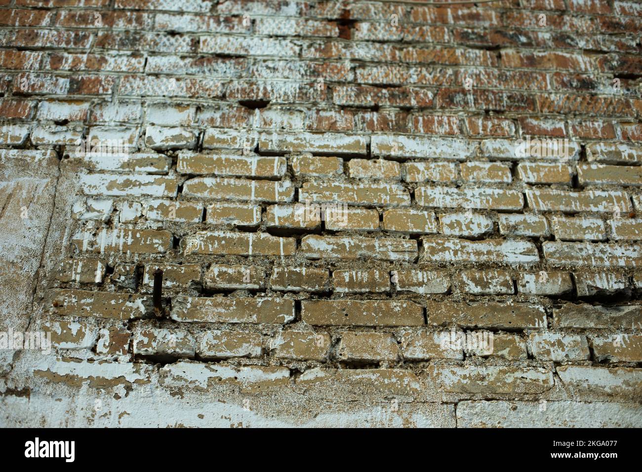 Old brick wall. Poorly painted wall of house. Details of building ...