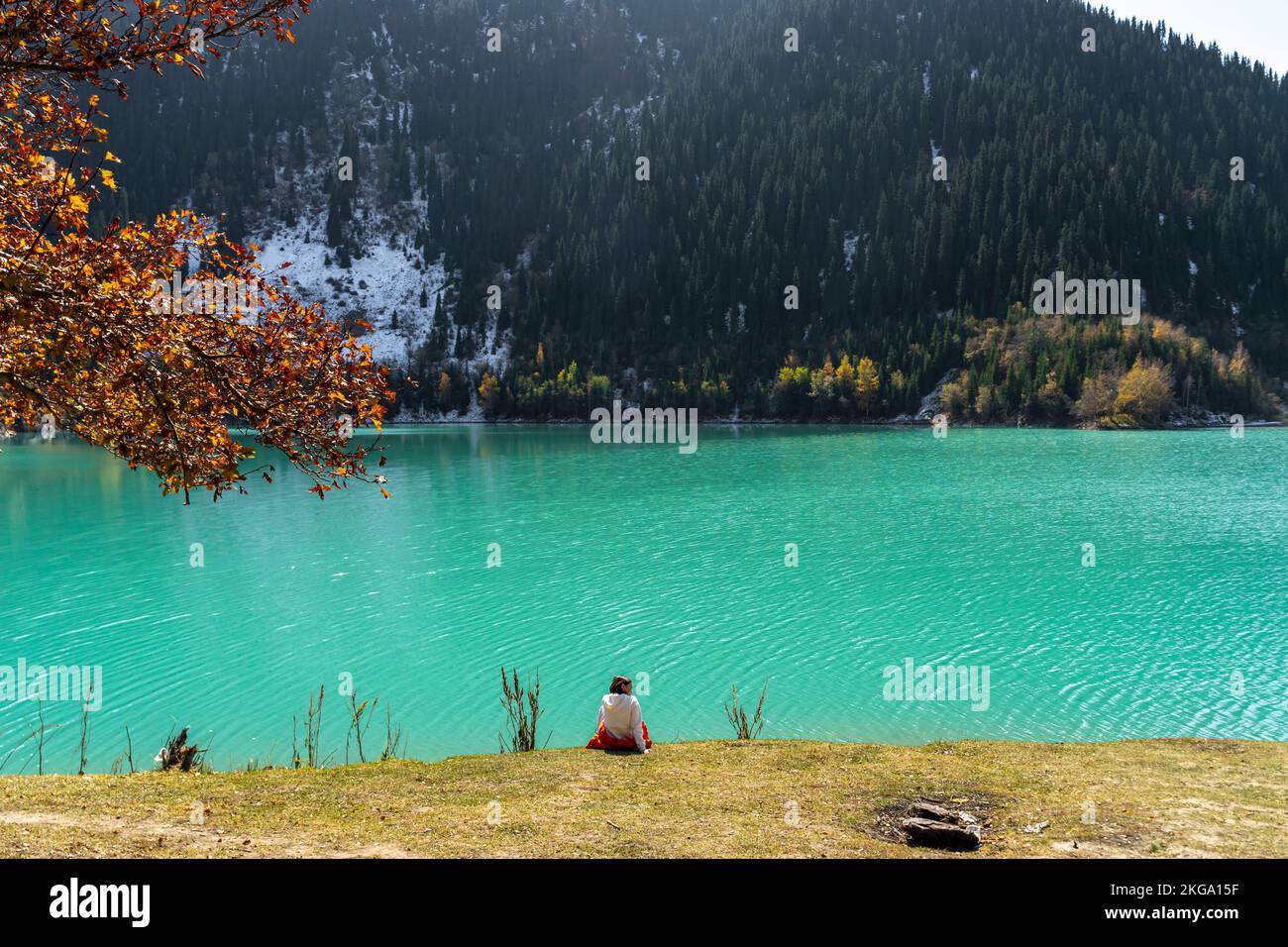 Lone tourist sitting at Issyk Lake, South Kazakhstan, Central Asia ...