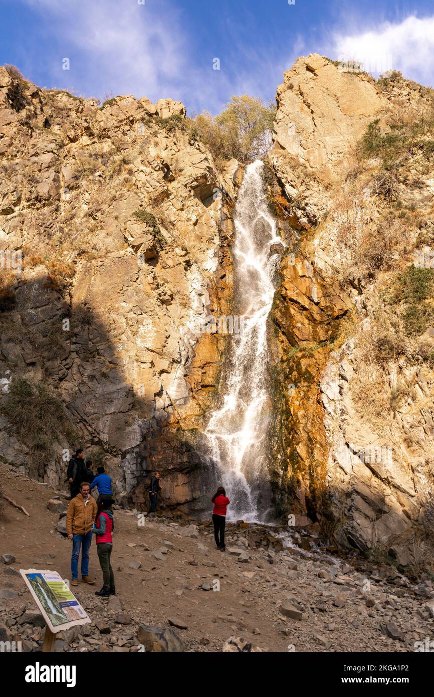 Tourists at Medvezhiy waterfall in Kazakhstan. Bear waterfall in Turgen ...