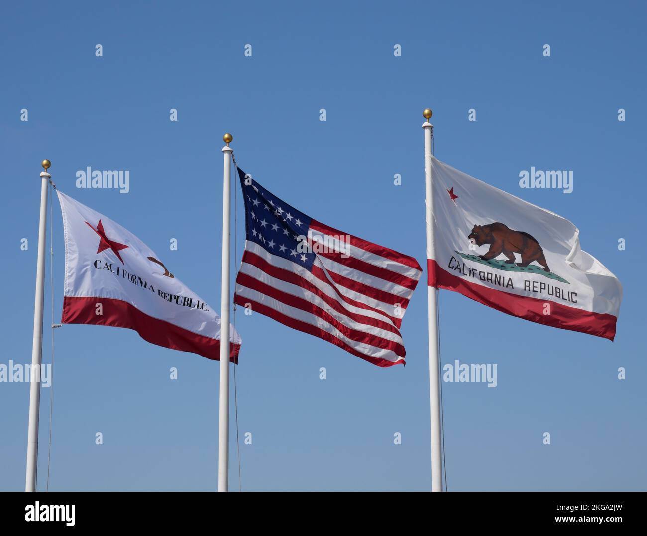 Flags of California and the United States of America against a clear ...