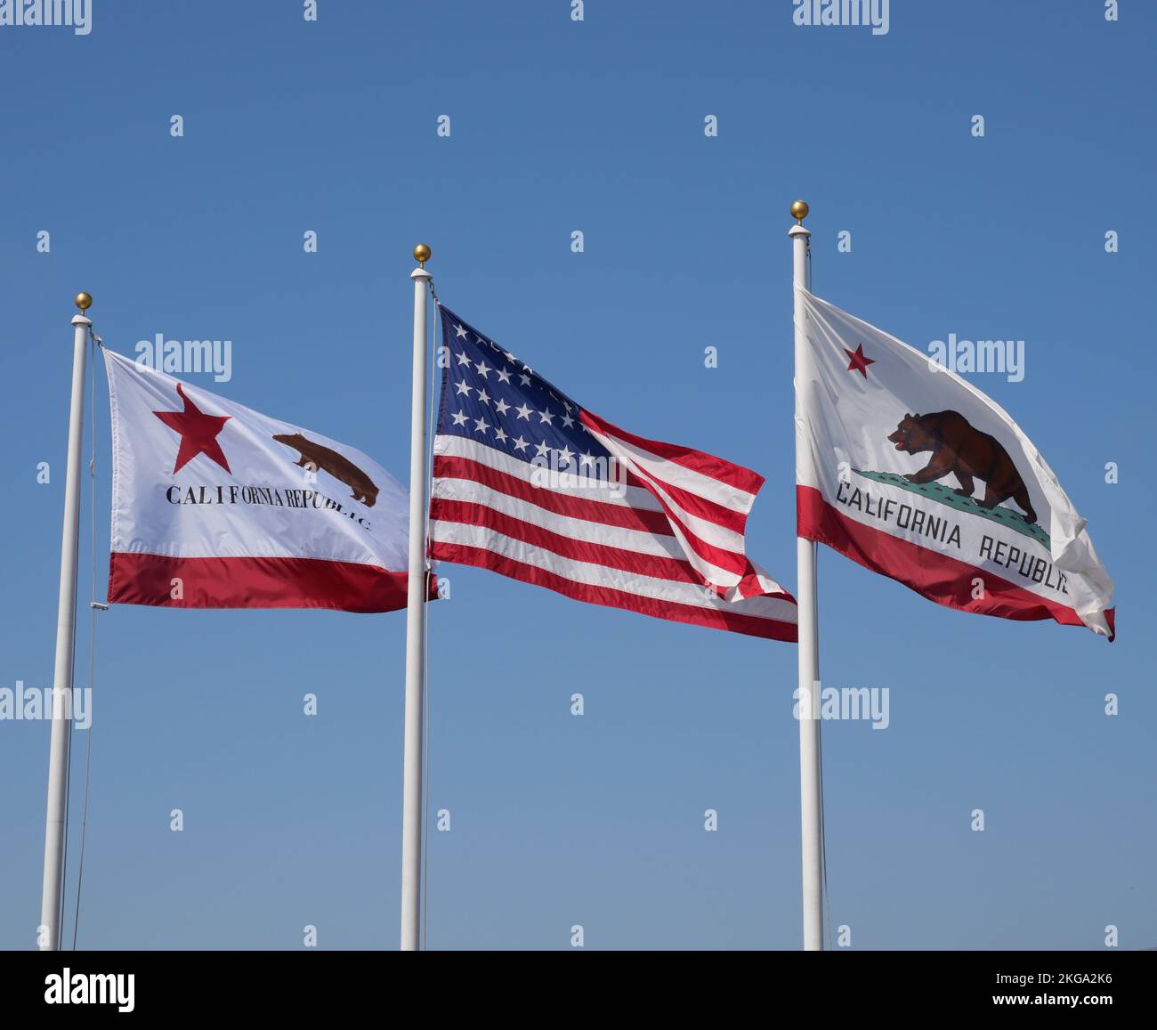 Flags of California and the United States of America against a clear ...