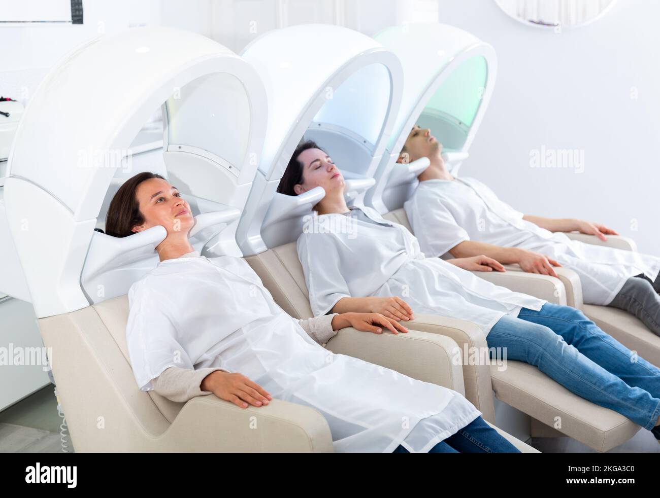 Clients of beauty salon relaxing on massaging chairs Stock Photo - Alamy