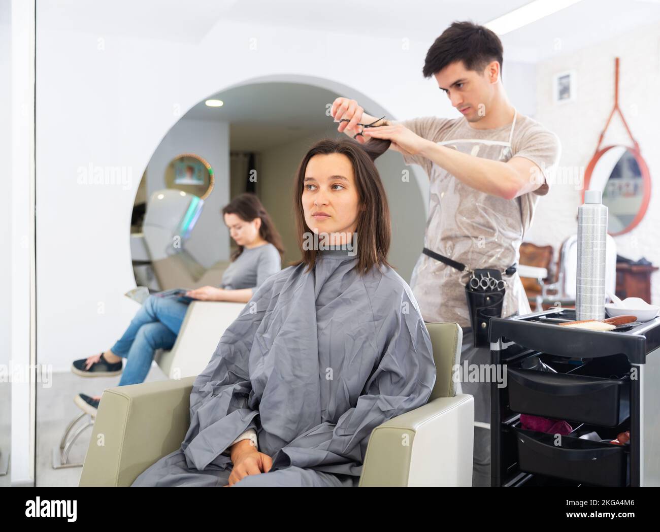 Female barber haircut doing male hi-res stock photography and images ...