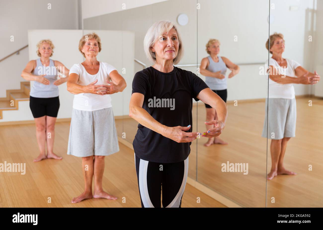 Elderly women practicing dance in the studio are standing in the 1st ...