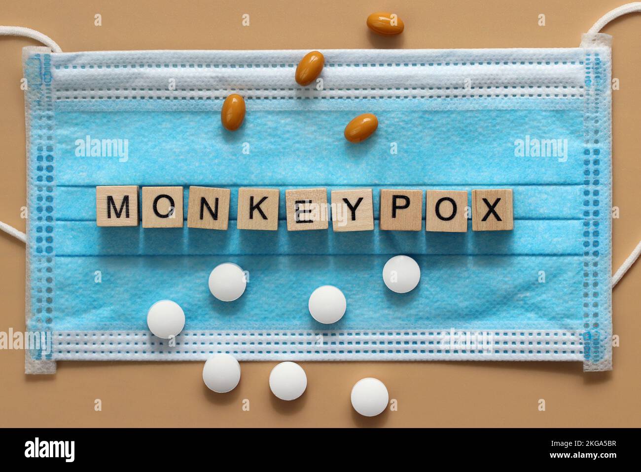 Monkeypox virus is laid out with wooden cubes on a surgical face mask ...