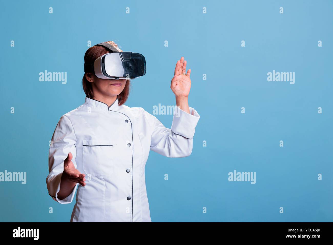Cheerful cook woman using virtual reality headset while cooking healthy ...