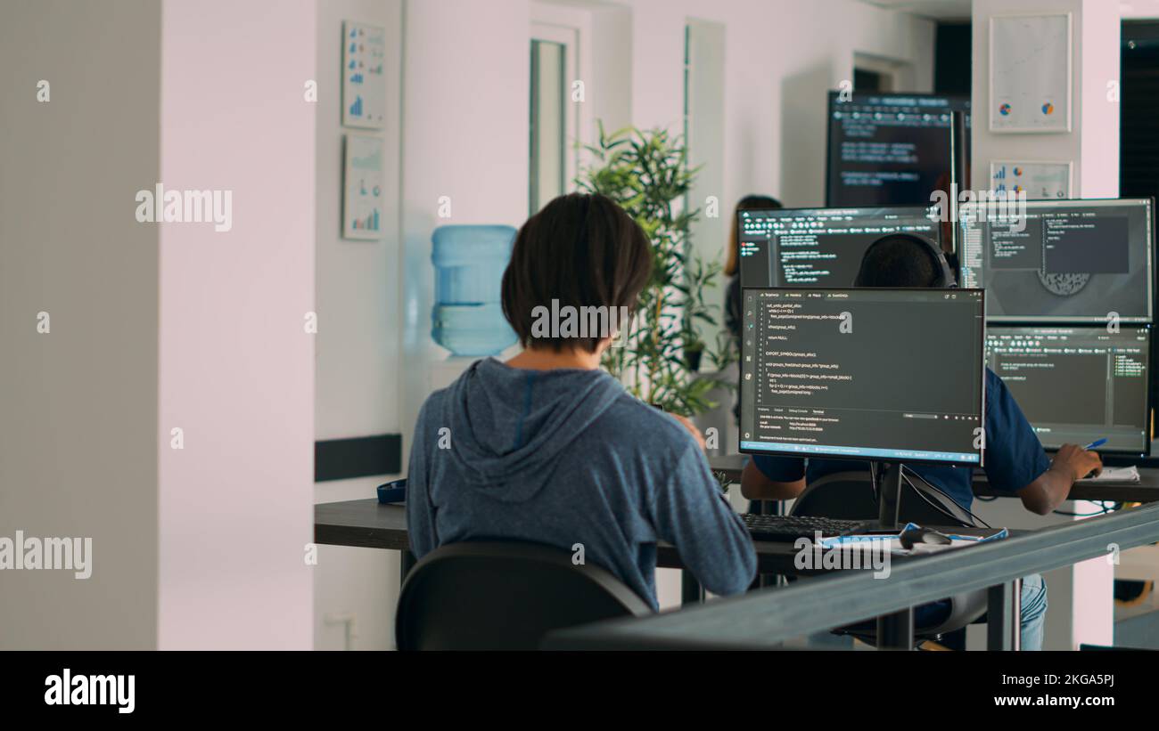 Multiethnic group of programers working on server code to develop new database user interface on ...