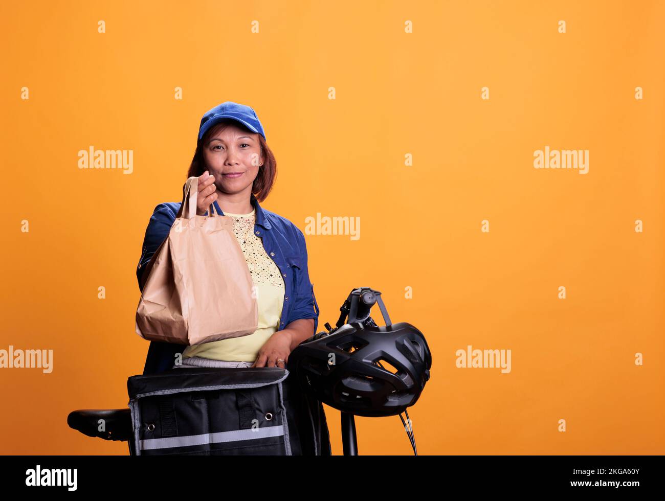 Takeaway food delivery employee wearing restaurant uniform while ...