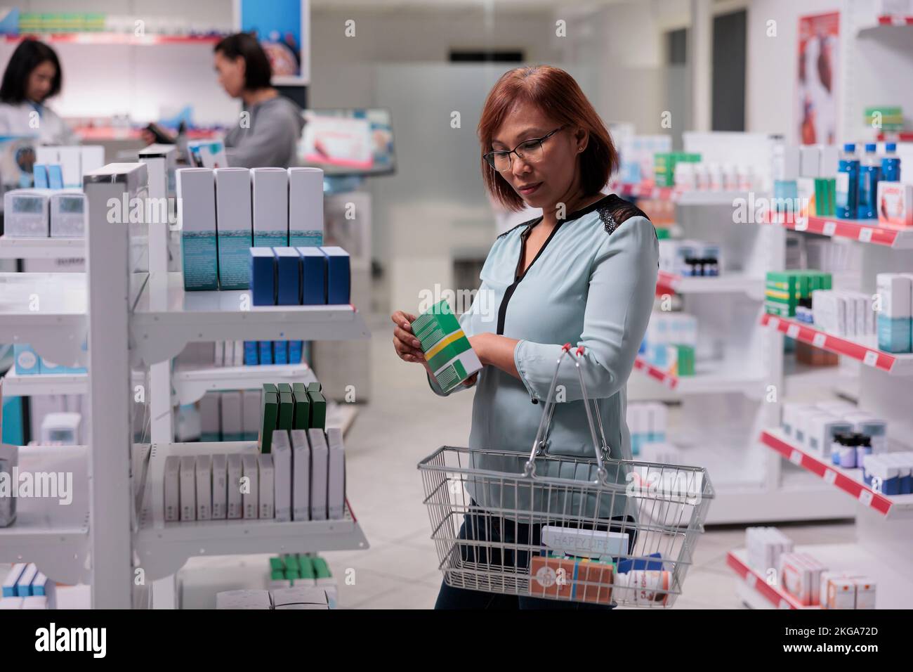 Female customer examining packages medicaments hi-res stock photography ...