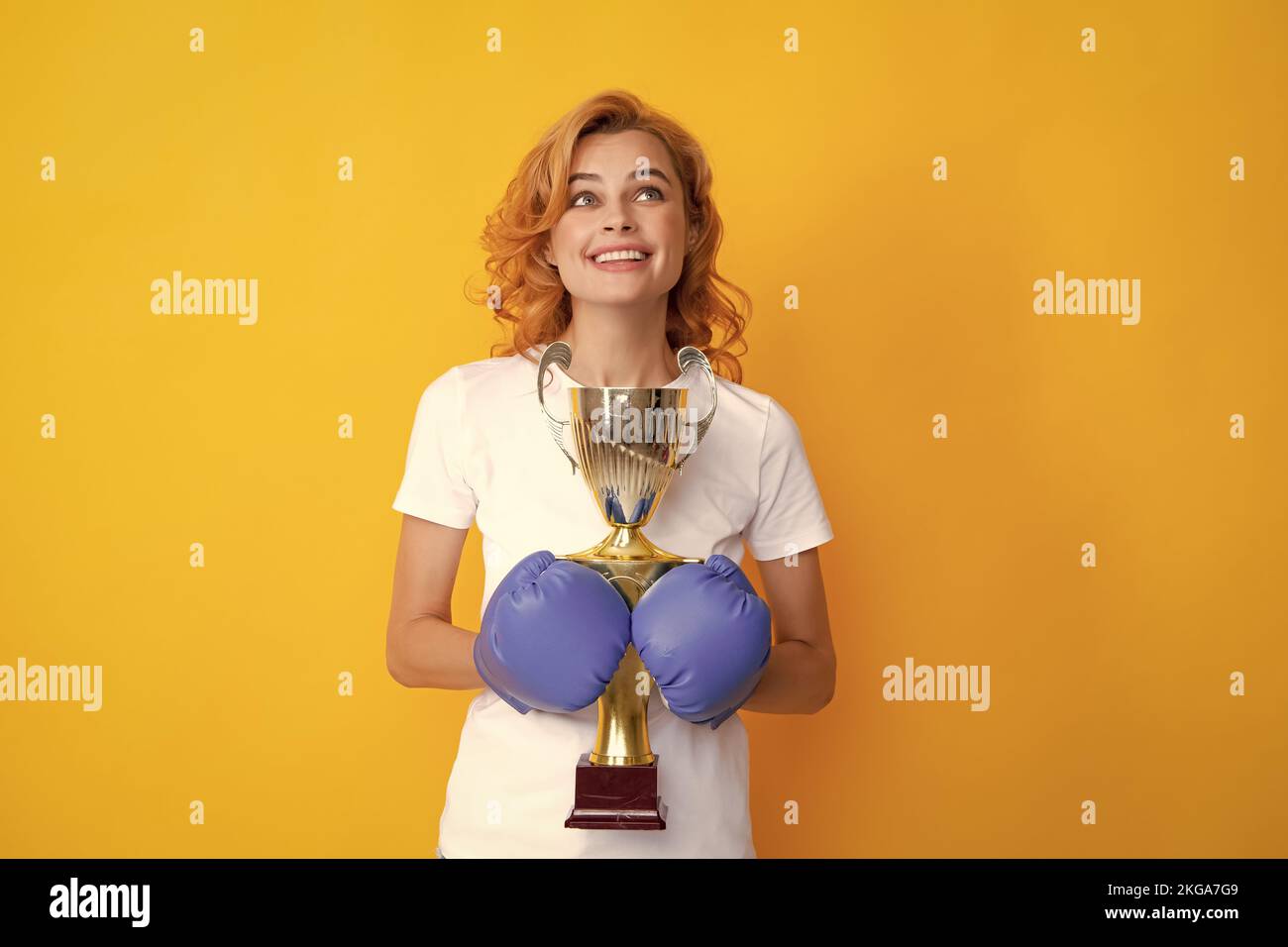 Cheerful woman celebrating victory. Woman in boxing gloves hold ...