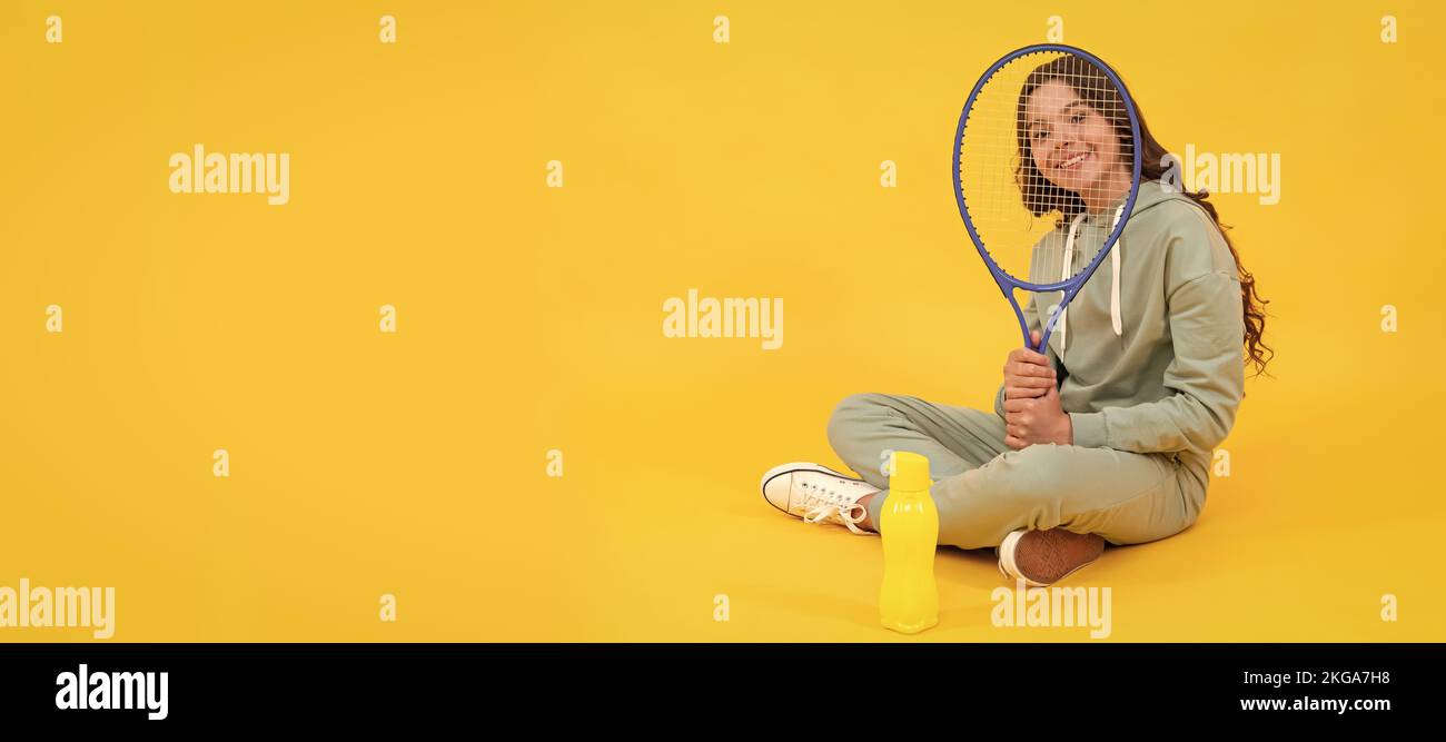 happy child sit in sportswear with squash racket and water bottle on ...