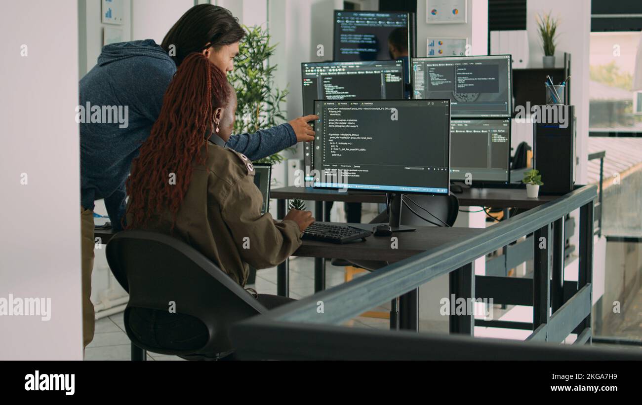 Diverse Team Of Ai Cloud Programers Talking About Coding Script In Front Of Computer Working On
