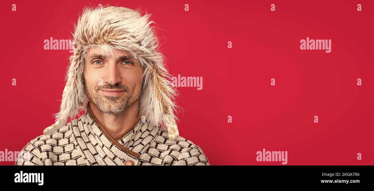 Man face portrait in winter warm hat, banner with copy space. smiling ...
