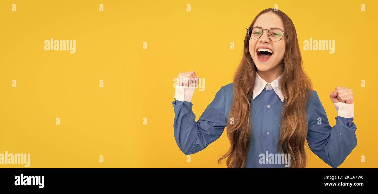 Happy back to school child show winning gesture yellow background ...