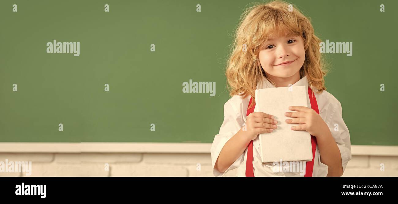 School pupil boy on blackboard, banner copy space. cheerful child boy ...