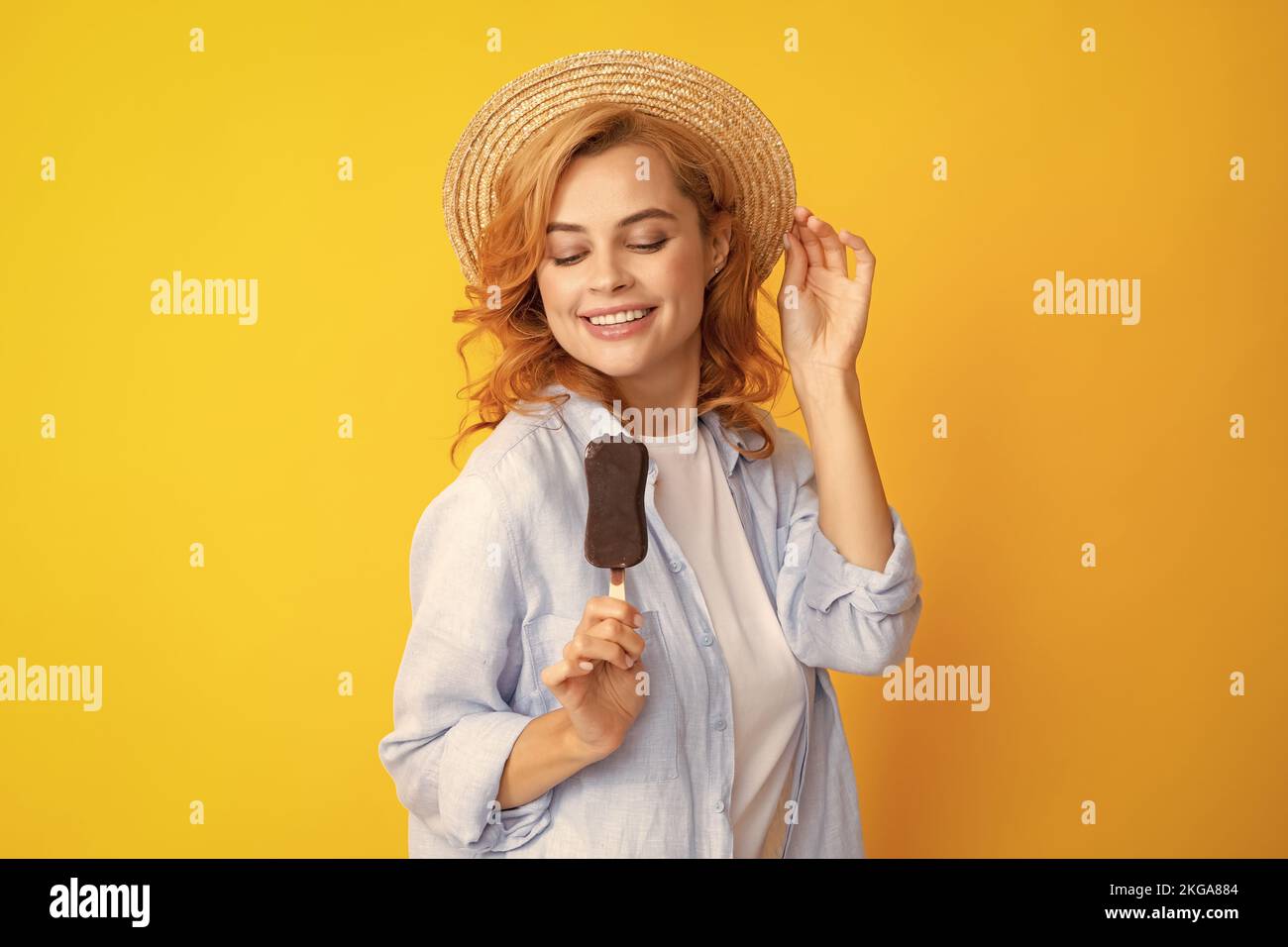 Portrait Of Beautiful Woman Eating Ice Cream On Orange Yellow