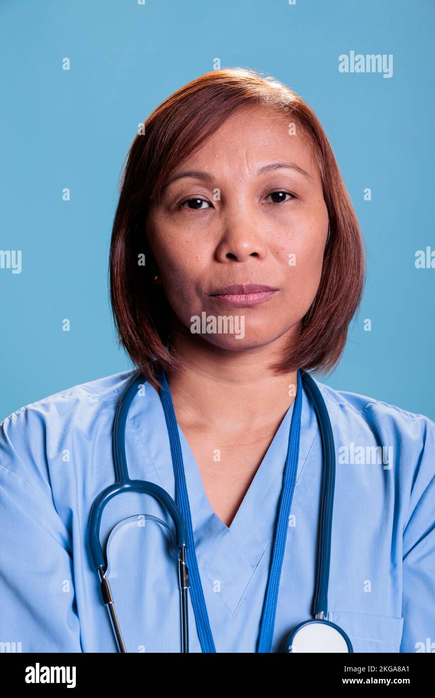 Portrait of confident specialist nurse with stethoscope waiting to ...