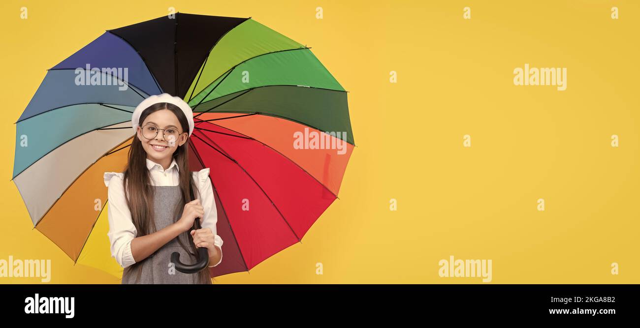 happy teen girl in glasses under colorful umbrella for rain protection ...