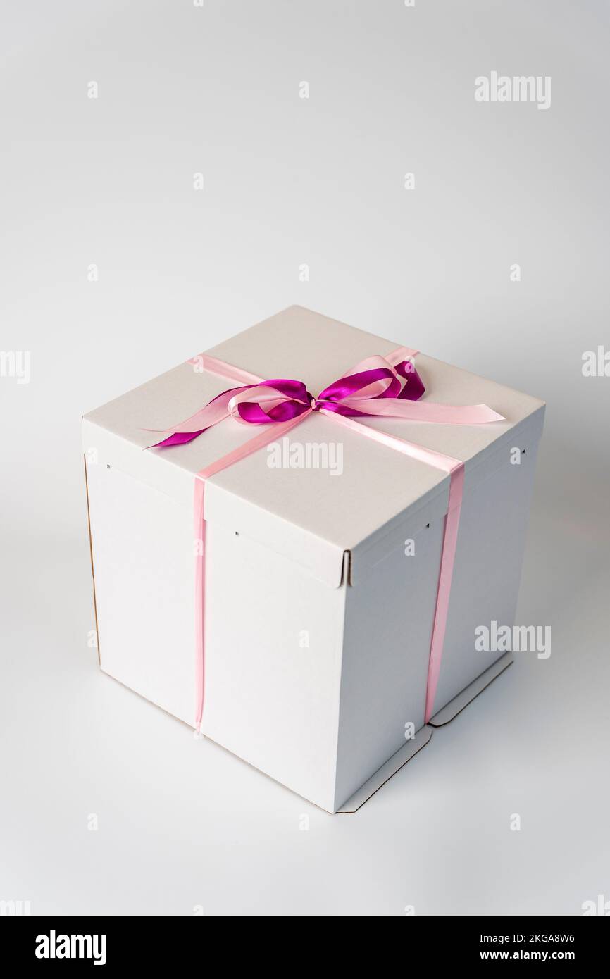 large white gift box tied with a red ribbon on a white background Stock ...