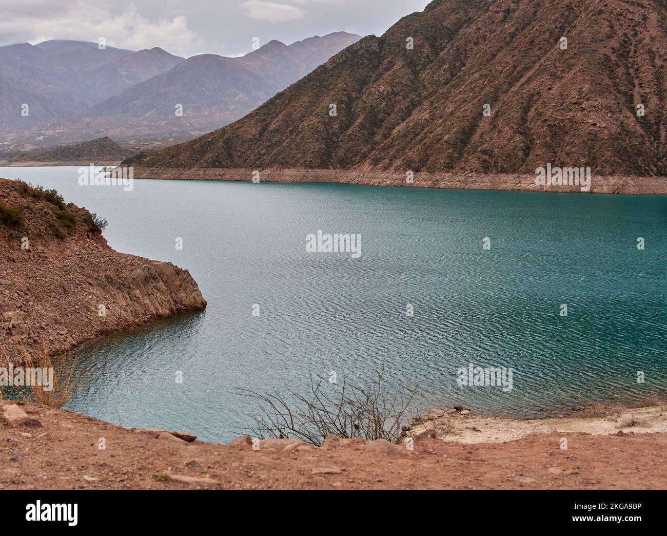 dam, turquoise water reservoir between mountains in Potrerillos ...