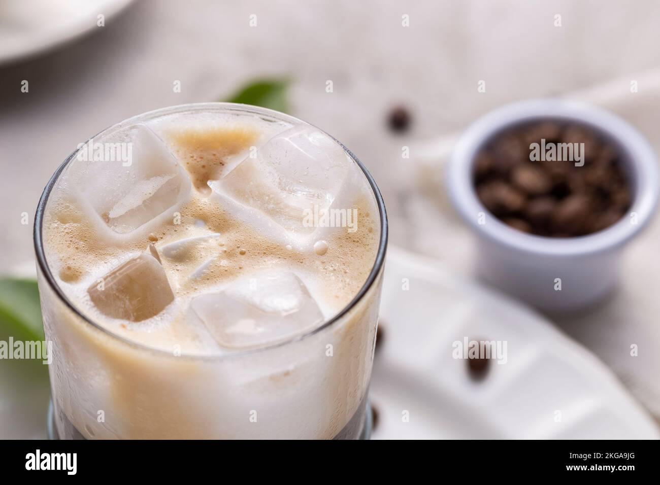 Refreshing iced coffee, with roasted coffee beans, on white background ...