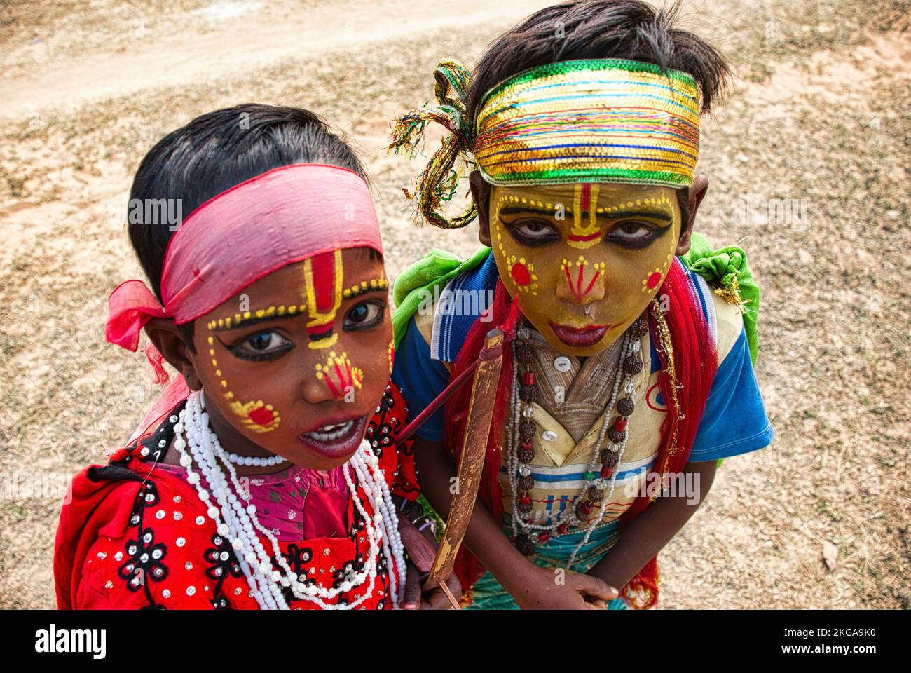 A high angle of two Indian children with face paintings in the Poush ...