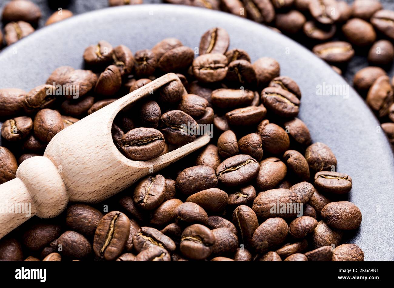 Roasted coffee beans with wooden spoon, closeup image, space for text ...