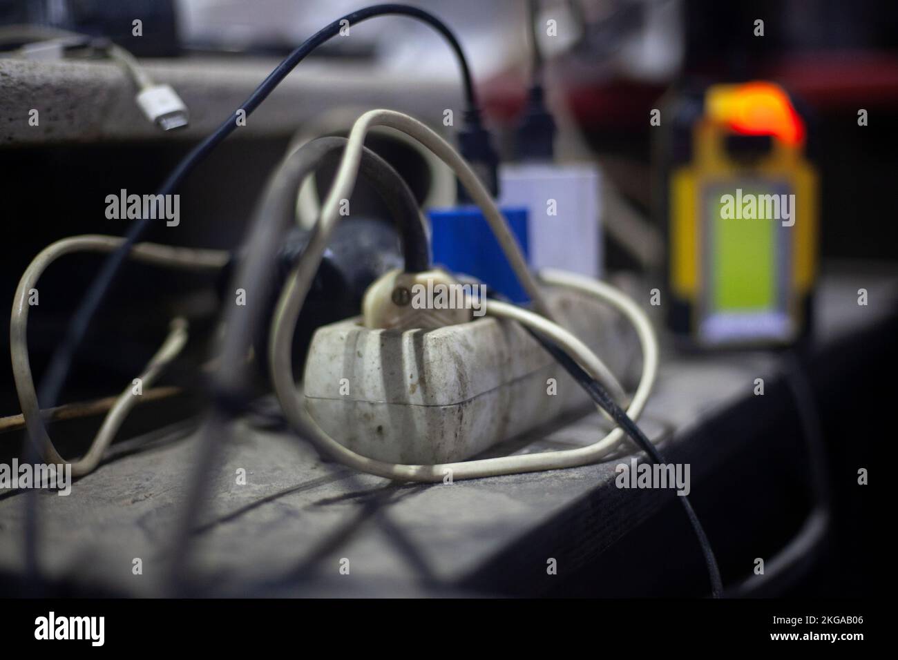 The charger is plugged in. Entangled wires from sockets of various ...