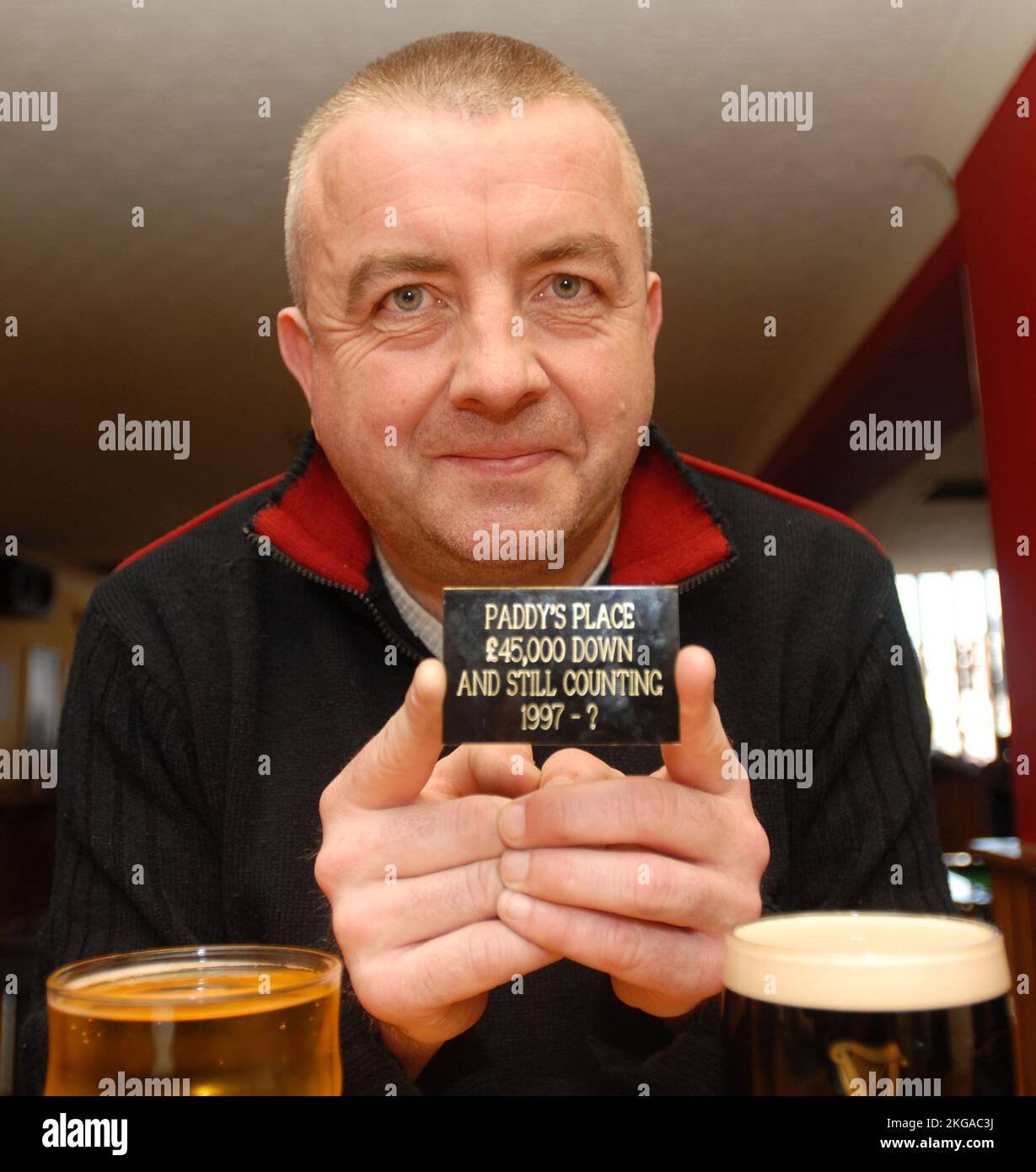 Paddy McCullen with the plaque that has been attached to the bar at his ...