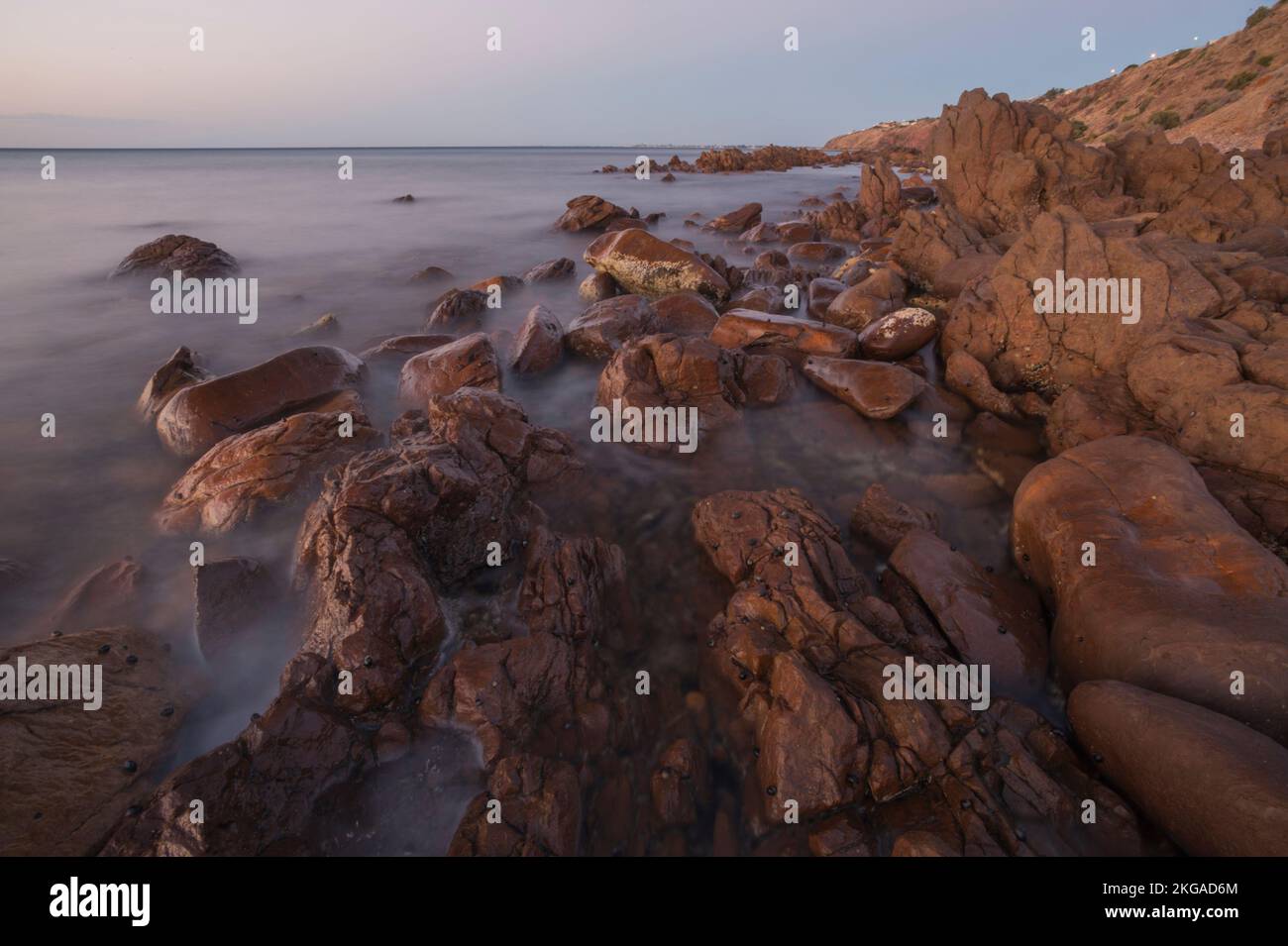 The smooth rock formations of the coast at Hallet Cove at sunset ...