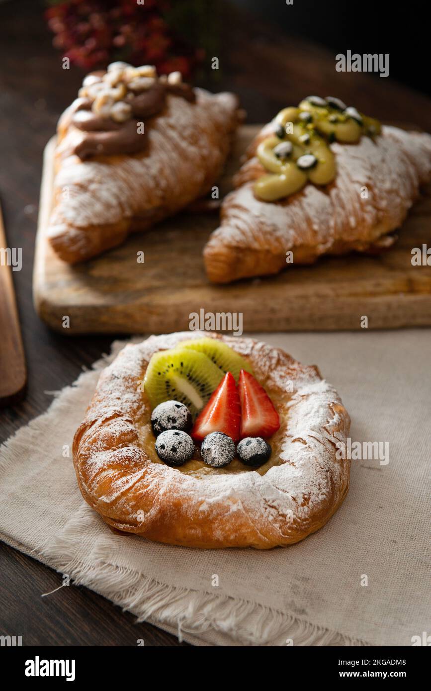 A vertical closeup shot of a gourmet round croissant pastry with ...