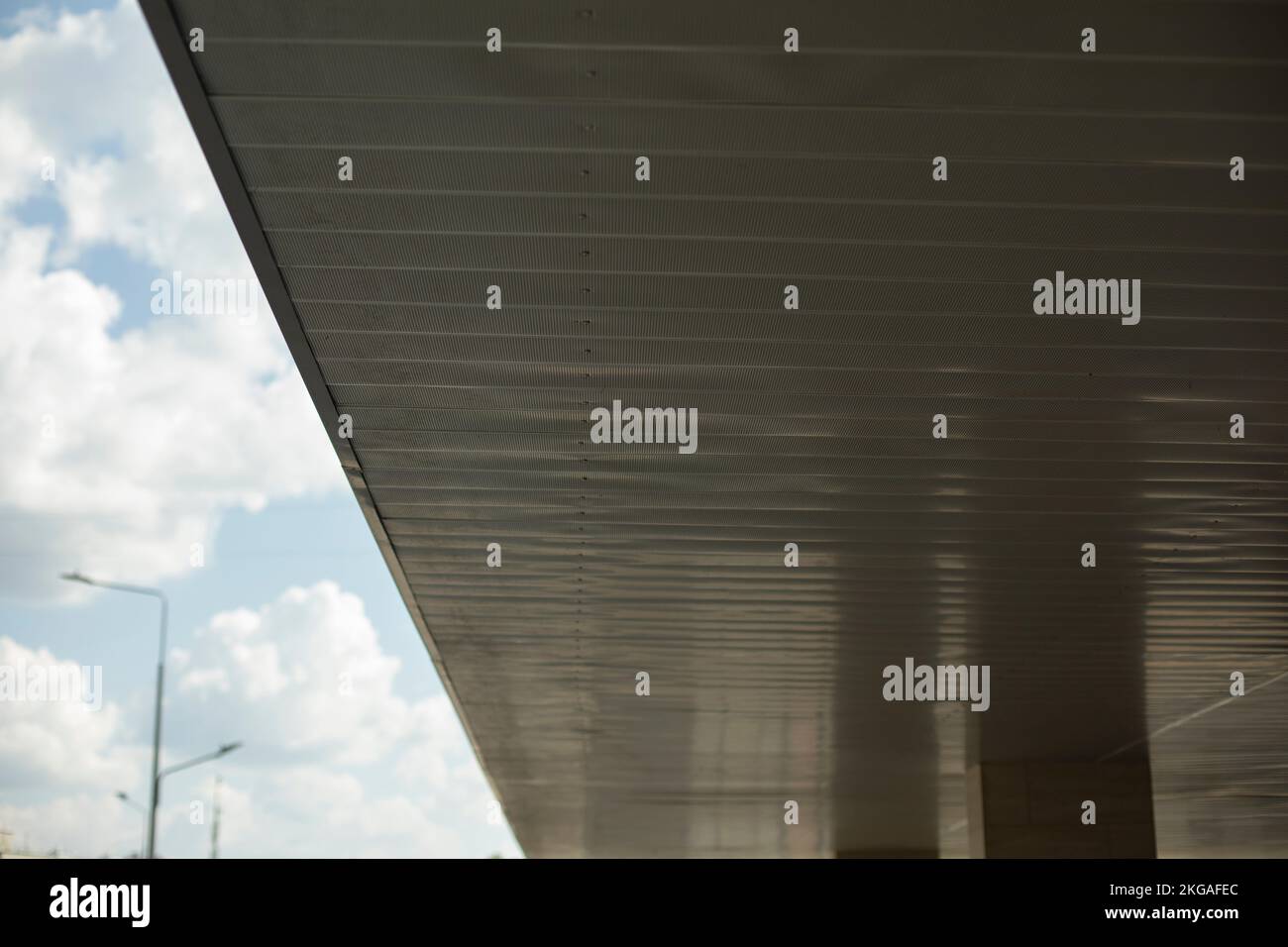 Ceiling of building canopy. Roof over entrance. Reflection in surface ...