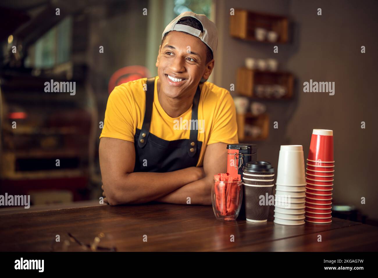 Smiling african barista leaning hi-res stock photography and images - Alamy