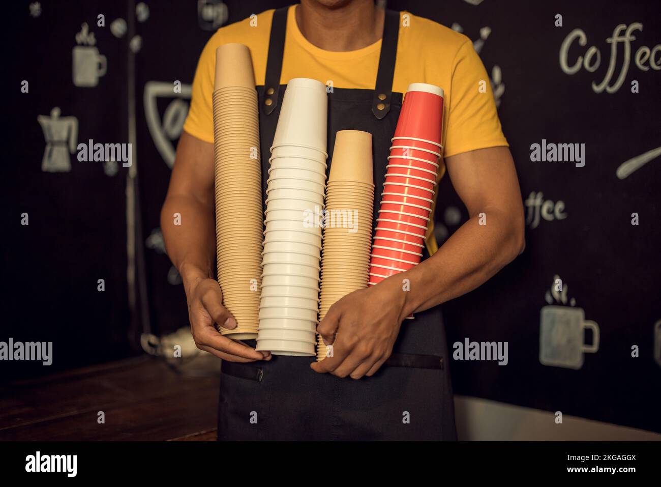 Bartender with a stack of paper cups in a cafe Stock Photo - Alamy