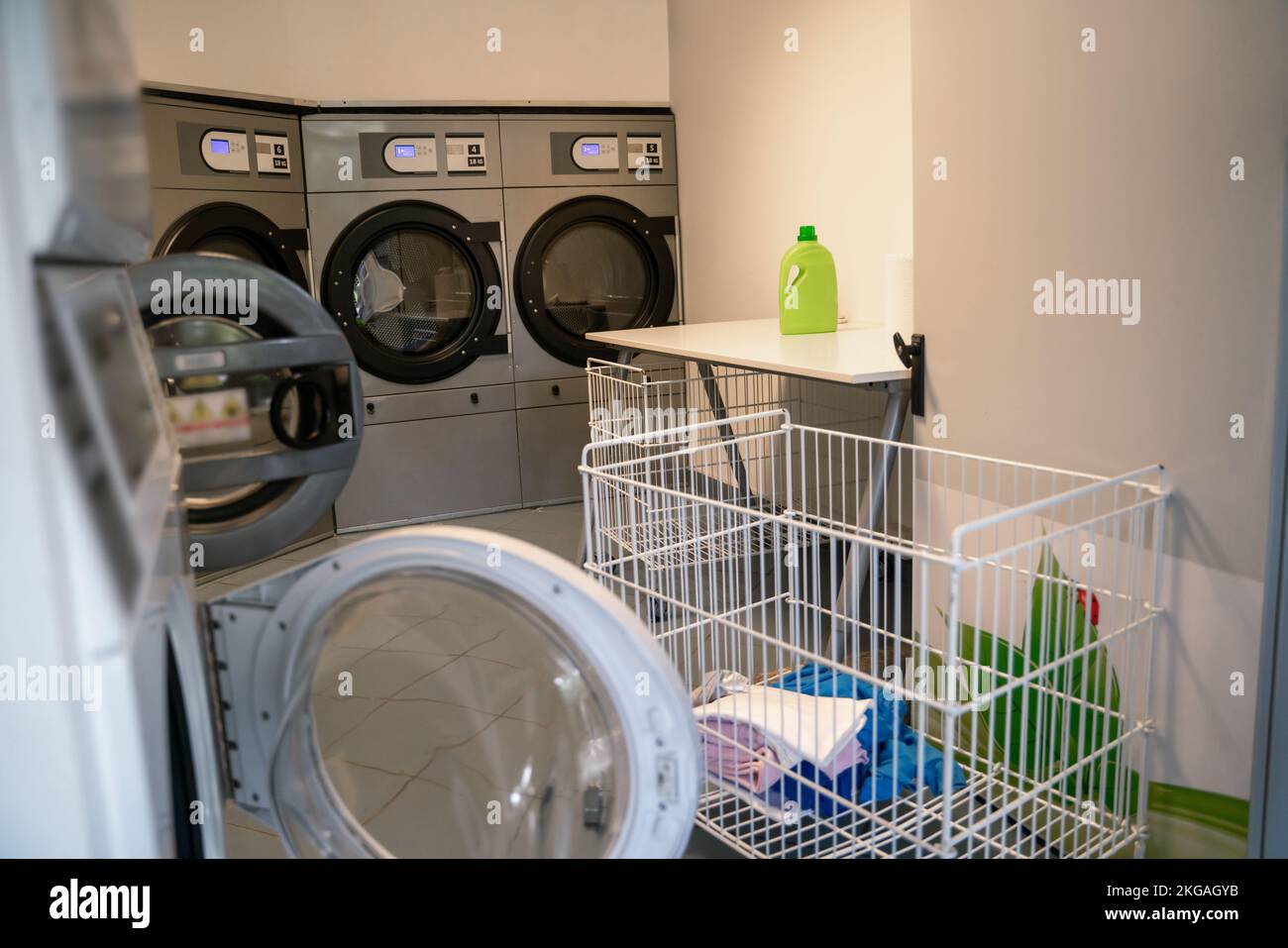 Row of front-loading washers in a laundry facility Stock Photo - Alamy