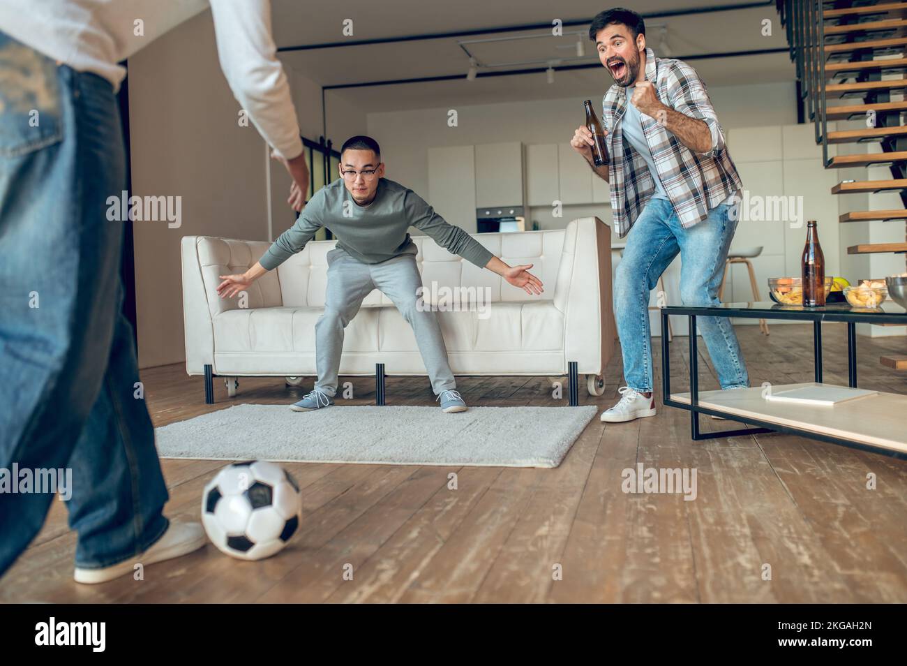 Young man supporting his buddies during the indoor sports game Stock ...
