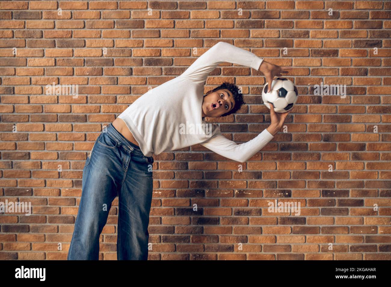 Energetic footballer performing a lateral ball throw Stock Photo - Alamy
