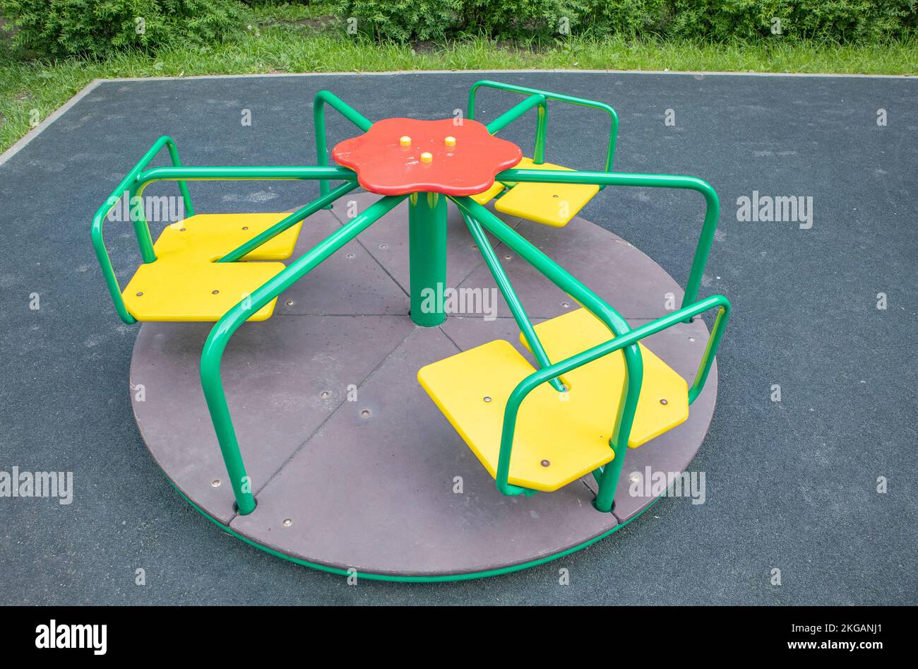 Multi-colored steel round carousel on the playground Stock Photo - Alamy